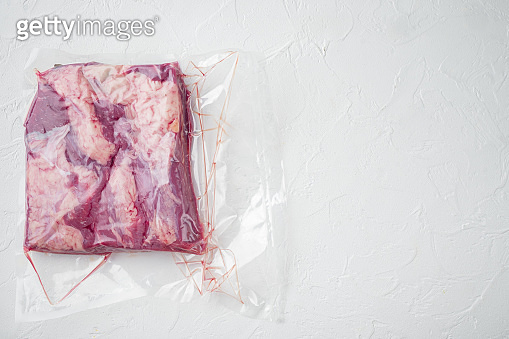 Cryovac packed meat Beef brisket in vacuum, on white stone background ...