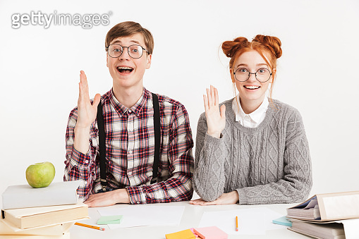 Funny couple of school nerds holding hands up for answer (1301037340 ...