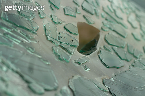 Broken glass in detail. Car windshield after the accident. Lots of ...