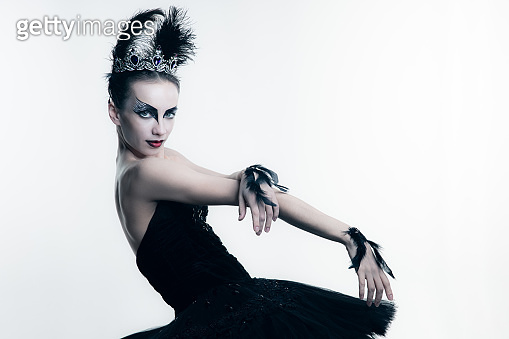 Side view of young ballerina wearing black tutu, stage dress and bright ...