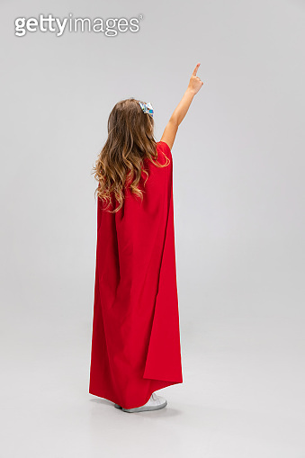 Back view of little girl, kid standing at her back to camera wearing ...
