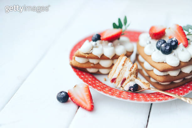 Delicious sweet flaky snack with berries on top on a plate. A sweet ...