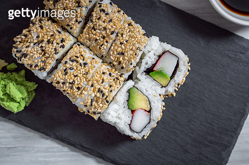 Fresh homemade delivery sushi nigiri seaweed rice roll with avocado ...