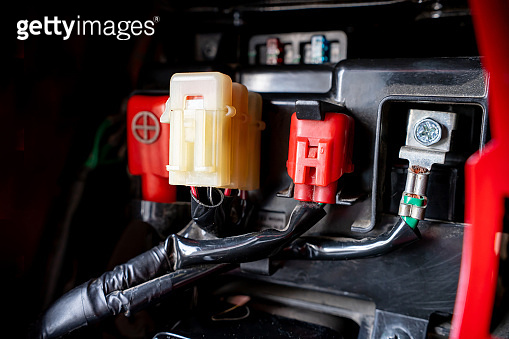 Fuse panel on battery box of motor cycle and plug and power supply ...