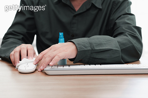 Close up hand a man cleaning mouse of computer and disinfection of ...