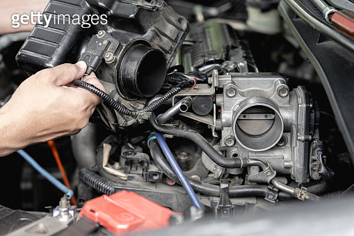 Close up old throttle Body of car in engine room with and a man hold ...