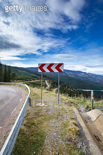 Road sign warning for dangerous curve ahead on Transrarau high altitude ...