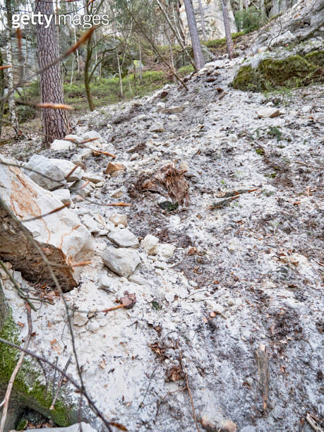 Collapsed rocky boulders fall down from sandstone rocks and landslide ...