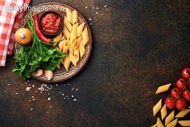 Pasta background. Pasta rigati, tomato ketchup sauce, olive oil, spices ...
