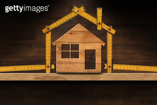 Folding Ruler House Shaped and Home Model on a Wooden Shelf (1299921528 ...