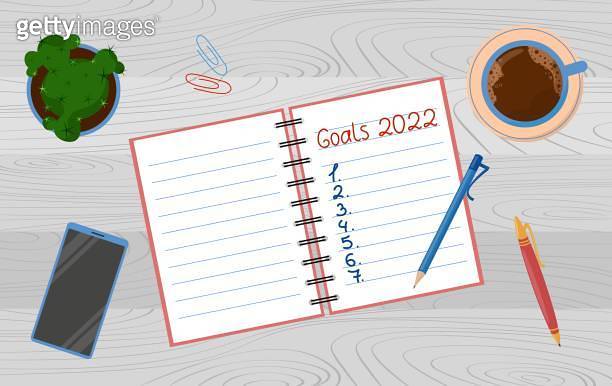 Goals for 2022 year. Target list written on notepad with pen. Planning ...