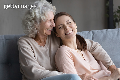 Smiling woman grown up child lean back to senior mom (1331541099) - 게티이미지뱅크