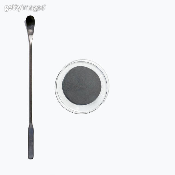 Zinc Powder in Chemical Watch Glass placed next to stainless spatula ...