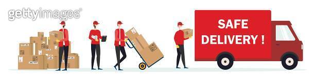 Safe delivery. Delivery by truck. A courier wearing a medical mask ...