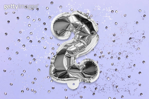 Silver foil balloon number, digit two on a lilac background with ...