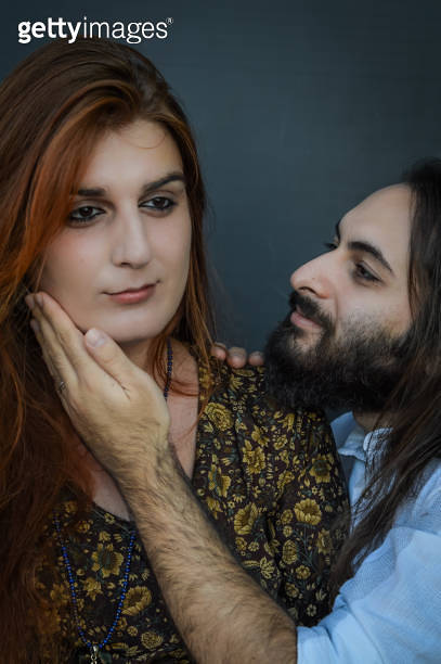 Portrait of a young couple where the young man with beard and long hair ...