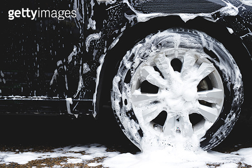 car wash with active foam soap. cleaning wheel tire. commercial ...