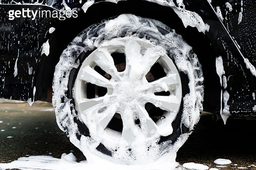 car wash with active foam soap. cleaning wheel tire. commercial ...