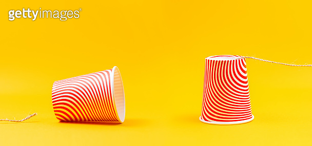 Two paper red cups with strings lying apart. Children's homemade toy ...