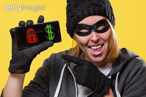 Cybercrime. Portrait of a woman in a black hat, gloves and mask, who ...