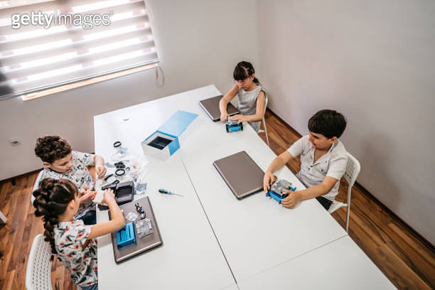 Students In Computer Coding Class Building And Programing Robot Vehicle ...
