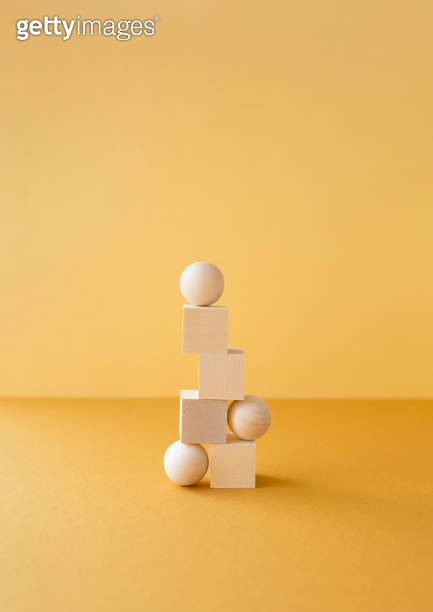 Wooden geometrical figures still life composition. Stack of solids ...