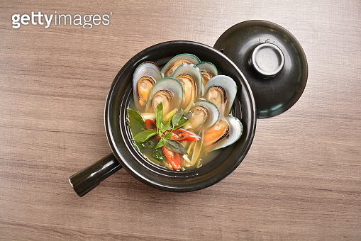 Thai hot spicy soup with muscle shell seafood and vegetable in clay pot ...