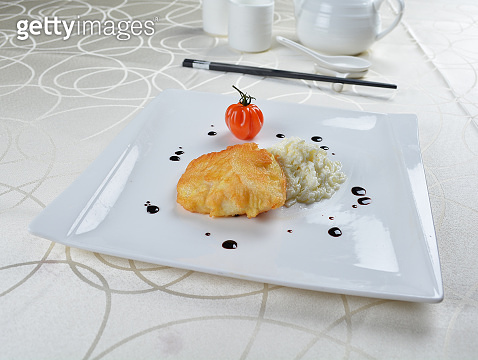 deep fried cod fish seafood with egg white and dark soy sauce in white ...