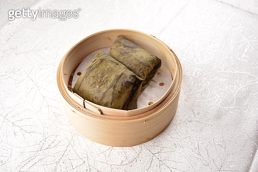 steamed sticky glutinous rice and meat wrapped in lotus leaf bamboo ...