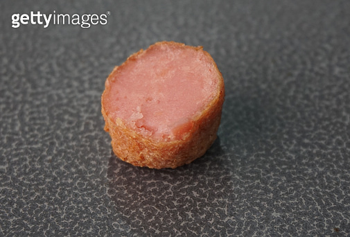 deep fried mini hot dog sausage luncheon meat with spicy sauce on dark ...