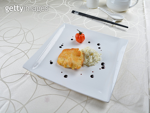 deep fried cod fish seafood with egg white and dark soy sauce in white ...
