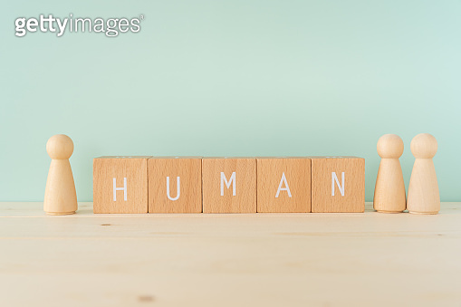 Human; Five wooden blocks with "HUMAN" text of concept and three human ...