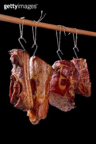 Delicious smoked meats suspended on a string. Meats prepared according ...