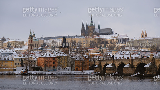 Touristic view of beautiful snowing Prague, Vltava river, Charles ...