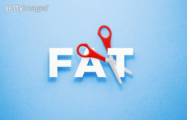 Cutting Fat Diet Concept - Scissors Cutting The Word Fat Over Blue ...