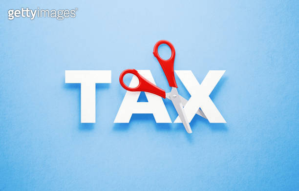 Cutting Taxes And Tax Reduction Concept - Scissors Cutting The Word Tax ...