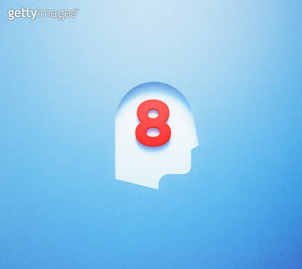 Red Number Eight Sitting Inside Of A White Cut Out Human Head Shape On ...