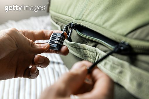 baggage safety - man close the suitcase with number combination lock ...