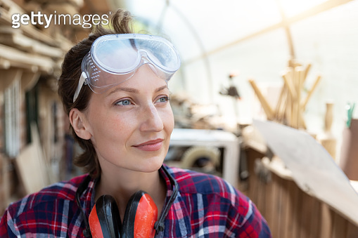 Young beautiful handy professional happy female strong carpenter ...