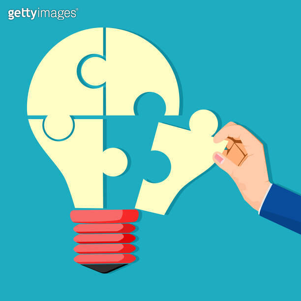 The human hand inserted the missing puzzle into the light bulb. full of ...