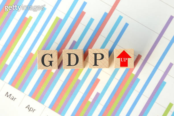 Wooden blocks with GDP words and upward arrow sign on business chart ...