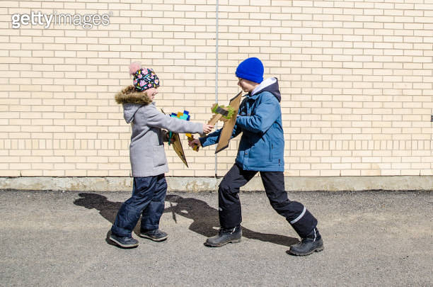 Two kids fighting with cardboard axes and shields 이미지 (1308451701) - 게티 ...