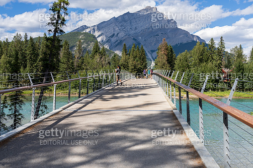 Banff Pedestrian Bridge and Bow River trail in summer sunny day. Banff ...