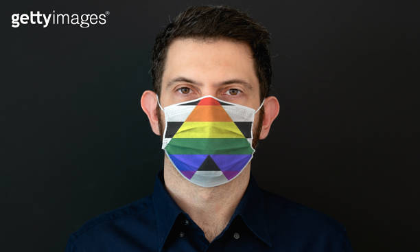 Man wearing a LGBT straight ally flag colors protective face mask. 이미지 ...
