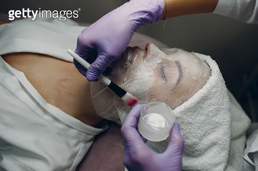Paraffin Face Mask gauze bandage Therapy Young Woman Receiving Facial ...