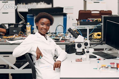 Scientist african american woman working in laboratory with electronic ...