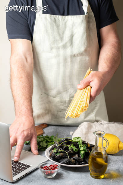 Man watching culinary master class online and learning how to cook ...