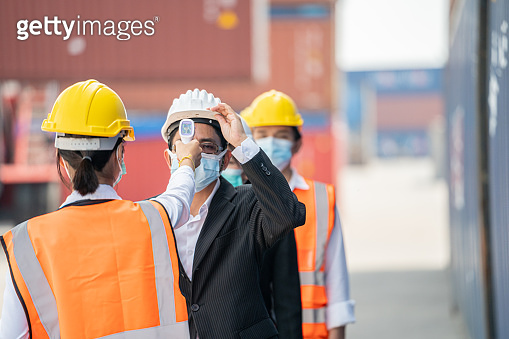 Factory woman worker in a face medical mask and safety dress used ...