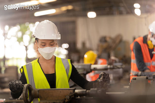 worker Factory people wearing face mask and safety suit. women working ...