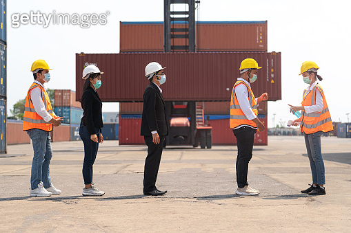 Factory woman worker in a face medical mask and safety dress using ...